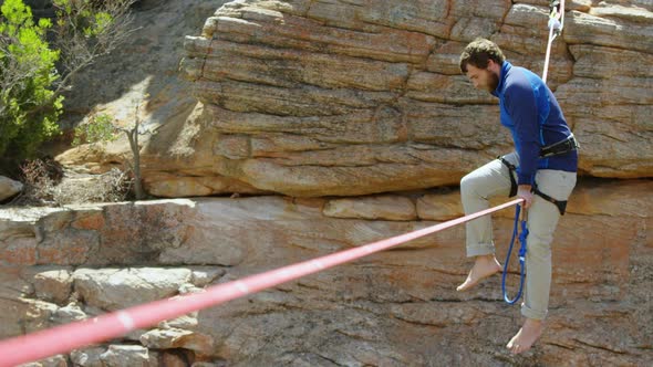Mountaineer trying to get on the rope for tightrope walking, Stock Footage