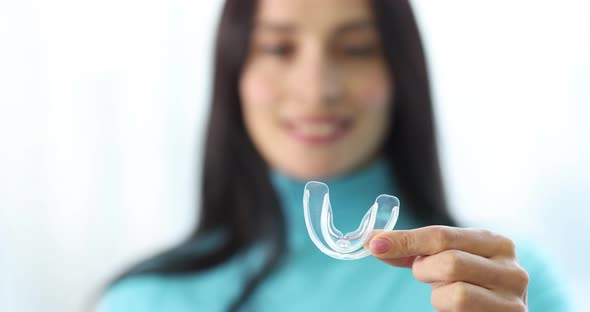 Woman Holding Plastic Night Guard for Teeth Closeup Movie Slow Motion ...