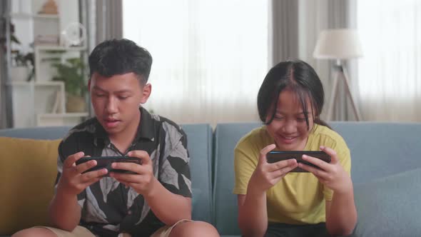 Asian Children Playing Video Games On Mobile Phone At Home, Stock Footage