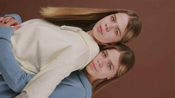 Vertical Portrait of Identical Twins Hugging, Stock Footage | VideoHive