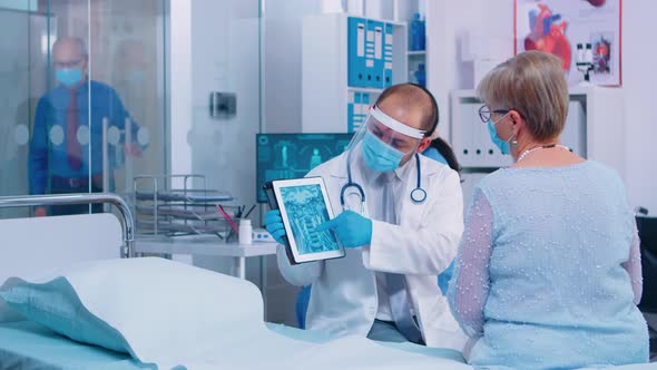 Physician Showing Retired Woman Radiology Scan on Digital Tablet, Stock ...