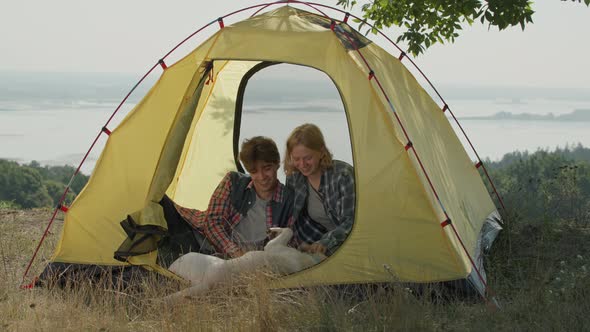 20s Family Petting Labrador Retriever Dog Lying in Camping Tent ...
