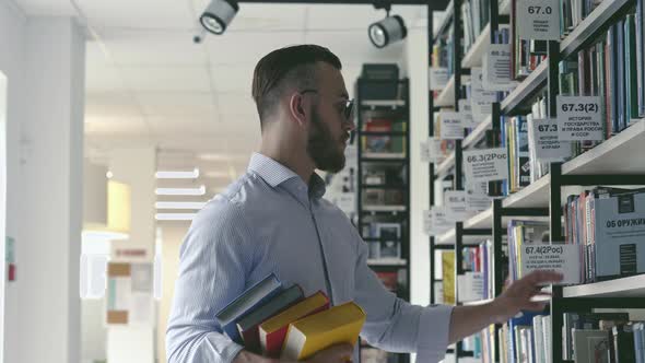 Young man in the library, Stock Footage | VideoHive