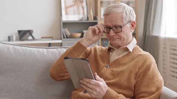 Smiling Senior Man Reading News on Digital Tablet, Stock Footage ...
