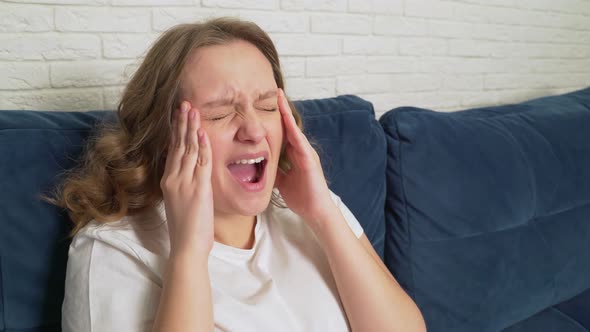 Young Woman Actively Massages the Temples of the Head Due to Headaches ...