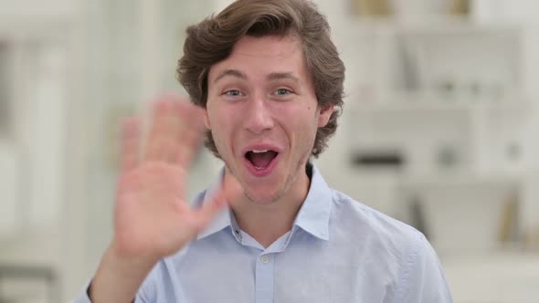 Portrait of Cheerful Young Businessman Waving Hello, Stock Footage