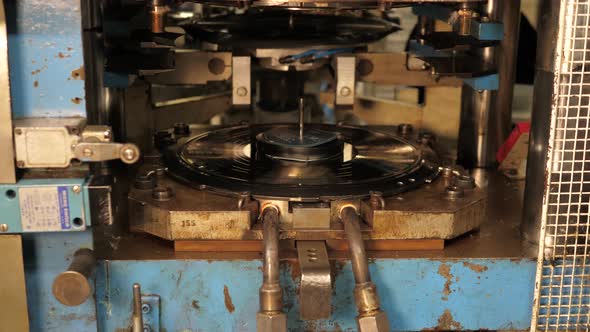 Vinyl record pressing machine in action, Making music record in a vinyl ...