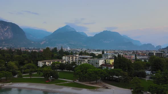 Aerial view of Riva del Garda city, overview at sunrise. Slide shot in ...