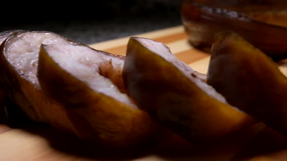 Super Closeup Panorama of the Smoked Eel Cut Into Portions on a Board ...