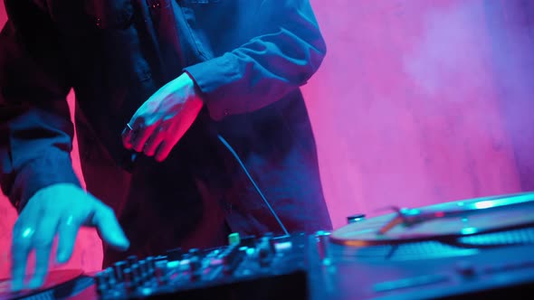 Closeup Modern DJ of Asian Appearance Performs a Music Track in Neon ...