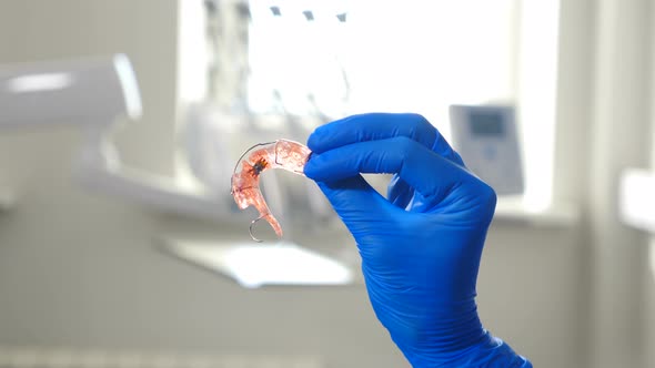 Dentist Demonstrating Dental Extension Device for Children To Correct ...