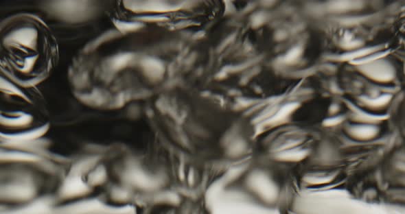 Bubbles Rising To A Moving Surface Of Water And Popping, Stock Footage