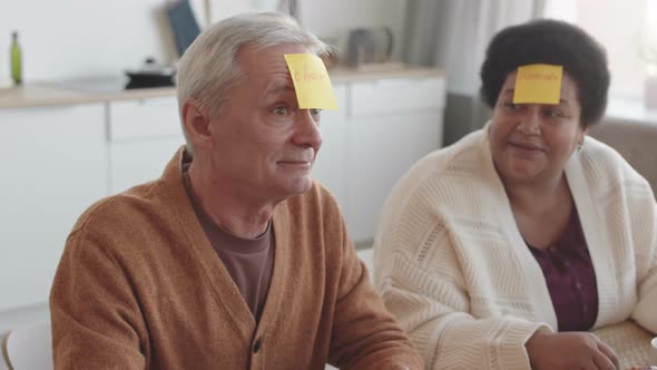 Older Man Winning Forehead Detective Game, Stock Footage | VideoHive