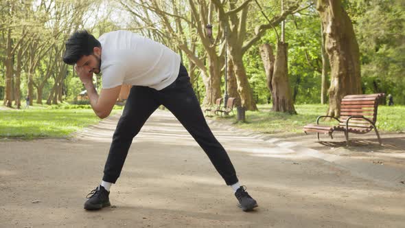 Healthy Muslim Guy in Sport Outfit Doing Flexible Exercises Outdoors ...