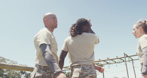 Happy diverse fit group of soldiers high fiving in field, at army ...