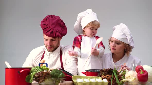Young Family Cooking in Chef Hat, Couple and Child Have Fun Cooking ...