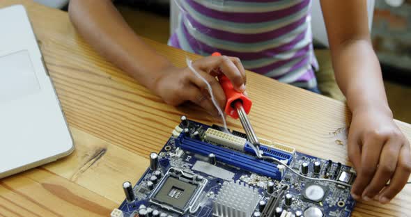Girl soldering a circuit board at desk , Stock Footage | VideoHive