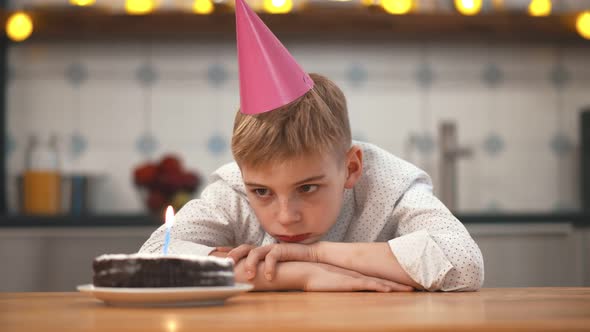 Portrait of Sad Birthday Boy Sitting in Kitchen Near Cake Alone, Stock ...