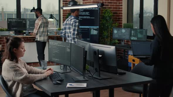 Software Engineer Typing Source Code on Computer Keyboard While Colleagues Sit Down at Desk ...