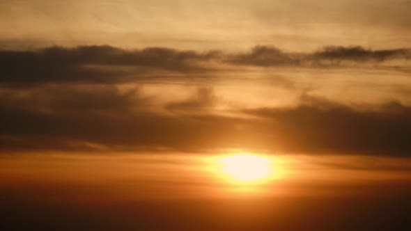 Sunset on a dark sky with evening clouds. The setting big evening sun ...