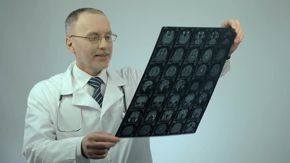 Happy Smiling Doctor Checking MRI Brain Scan Satisfied With Treatment ...