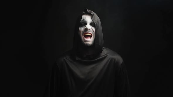 Grim Reaper with Scary Laughing Over Black Background, Stock Footage