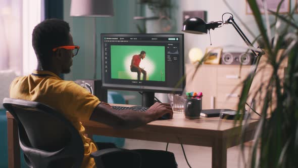 African American Man Editing Video with Chromakey Background, Stock Footage