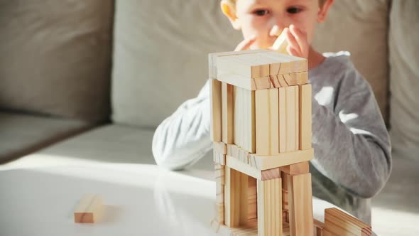 Child Crash a Tower From Wooden Blocks Crying Sitting on the Sofa at ...