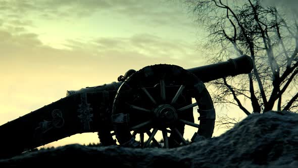 Old-fashioned heavy cannon on wheels firing a bronze ball on a night ...