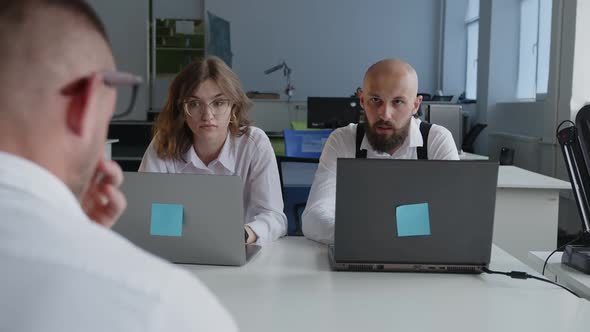 Coworkers Disscuss Some Online Work Together in the Office, Stock Footage