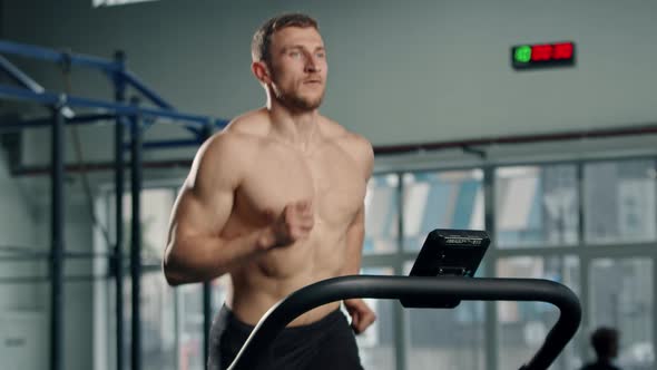 Male athlete athlete is doing cardio training on a treadmill ...