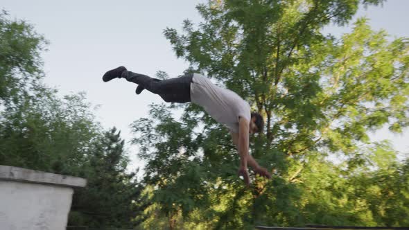 Male Parkour Athlete Performs a Trick with Overcoming Obstacles, Stock ...
