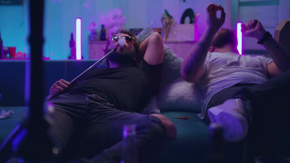 Men Chilling on Sofa During Night Party, Stock Footage | VideoHive