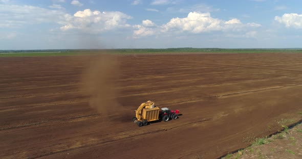 Peat Harvesting Machine Tractor Working on Field Aerial View, Stock Footage