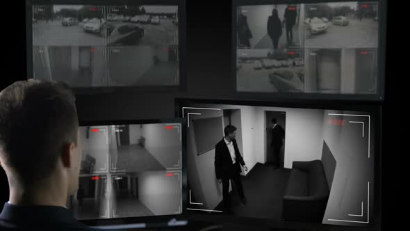 Male Security Operator Watching Surveillance Cameras, Illegal Business ...