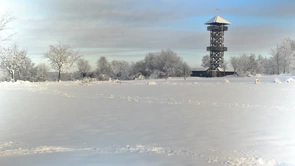 Timelapse of tourists visit medieval watchtower in snowy park in ...
