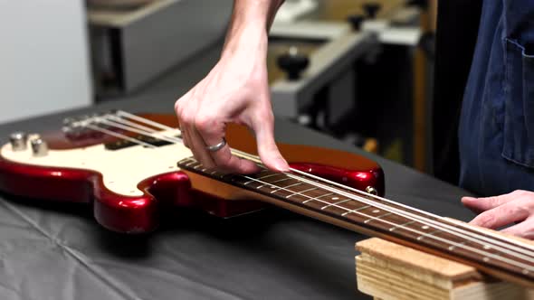 Putting new strings on an electric guitar., Stock Footage | VideoHive