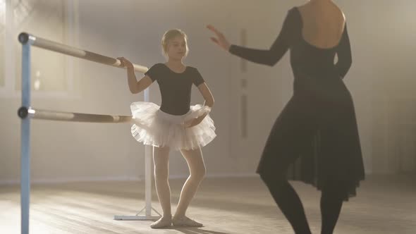 Smiling Motivated Beautiful Girl Learning Plie Position Looking at ...