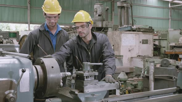 Engineer man training with foreman for apprentice using lathe ...
