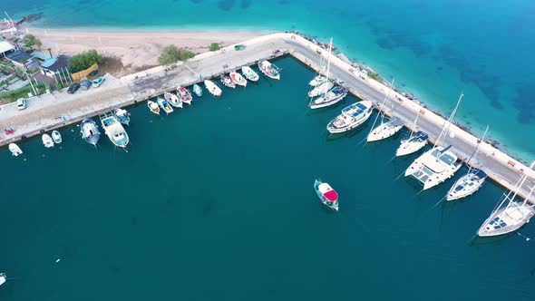 Small fishing boat entering port near sailboats and catamarans in a ...
