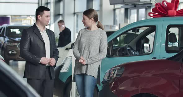 Cheerful Caucasian Young Woman Taking Car Keys From Dealer, Clapping ...