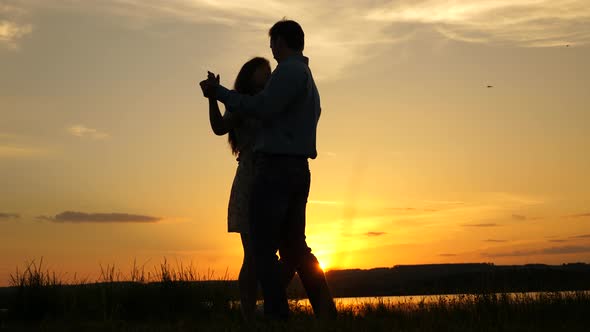Young Couple Dancing at Sunset on Beach. Loving Man and Woman Dance in ...