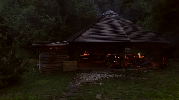 Aerial view of a wooden open hut with people enjoying the night in Soca ...