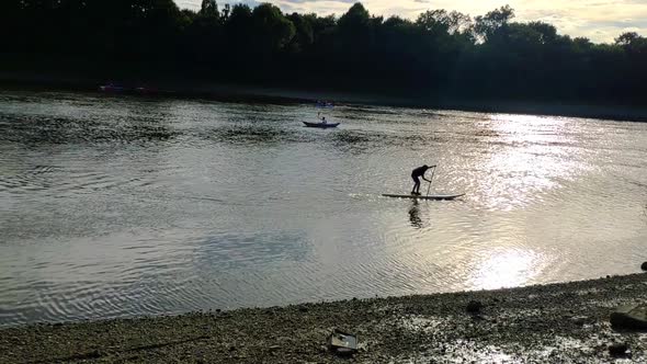 A kid is seen paddling on a Stand Up Paddle board on river Thames in ...