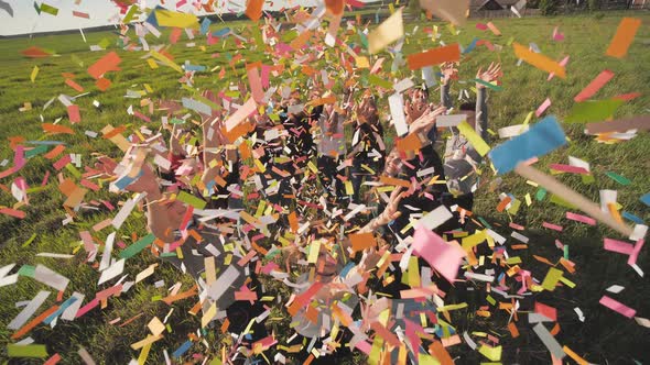 A Group of Friendly Friends Toss Up Candy at Sunset in a Field, Stock ...