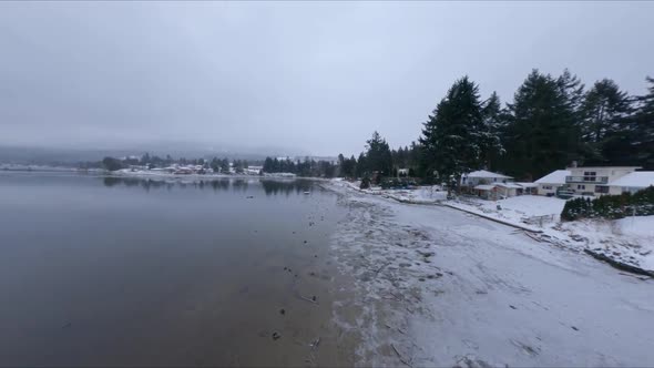 Snowy Shoreline Of Beach And Marina Of Sechelt Inlet During Winter In ...