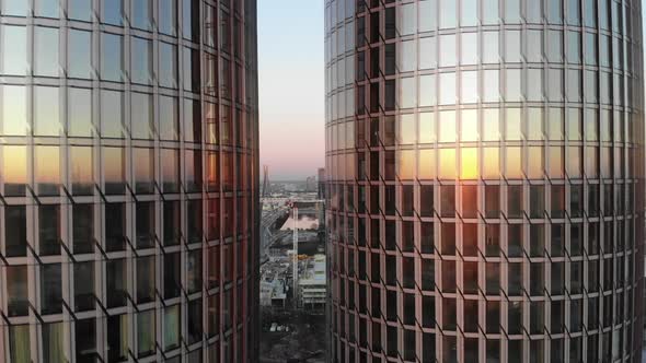 Close up aerial reveal of Zunda glass towers on a sunset with city of ...
