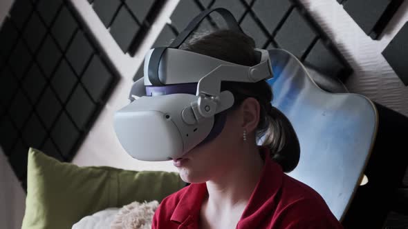 Young Woman in VR Helmet Sitting on Sofa and Communicating in Virtual ...