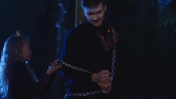 Medium Shot of Vampire Caught in Darkness Standing at Tree in Forest As ...