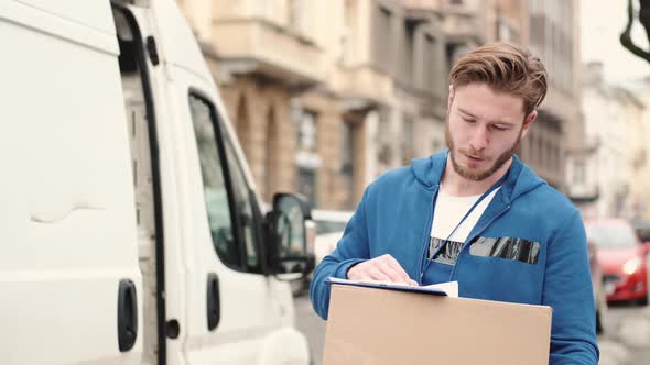 Delivery Driver Checking His List of Parcels, Stock Footage | VideoHive